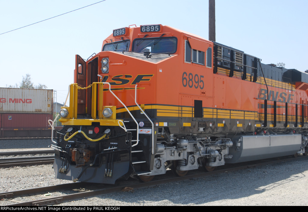 BNSF 6895 with her crew door ajar waits for a crew as she sits on the siding near the Main Line ...